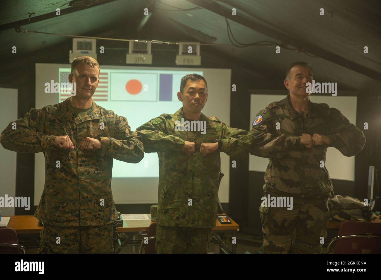 Lt. Col. Jeremy Nelson, commander of Marine Forces (left), Col. Masashi ...