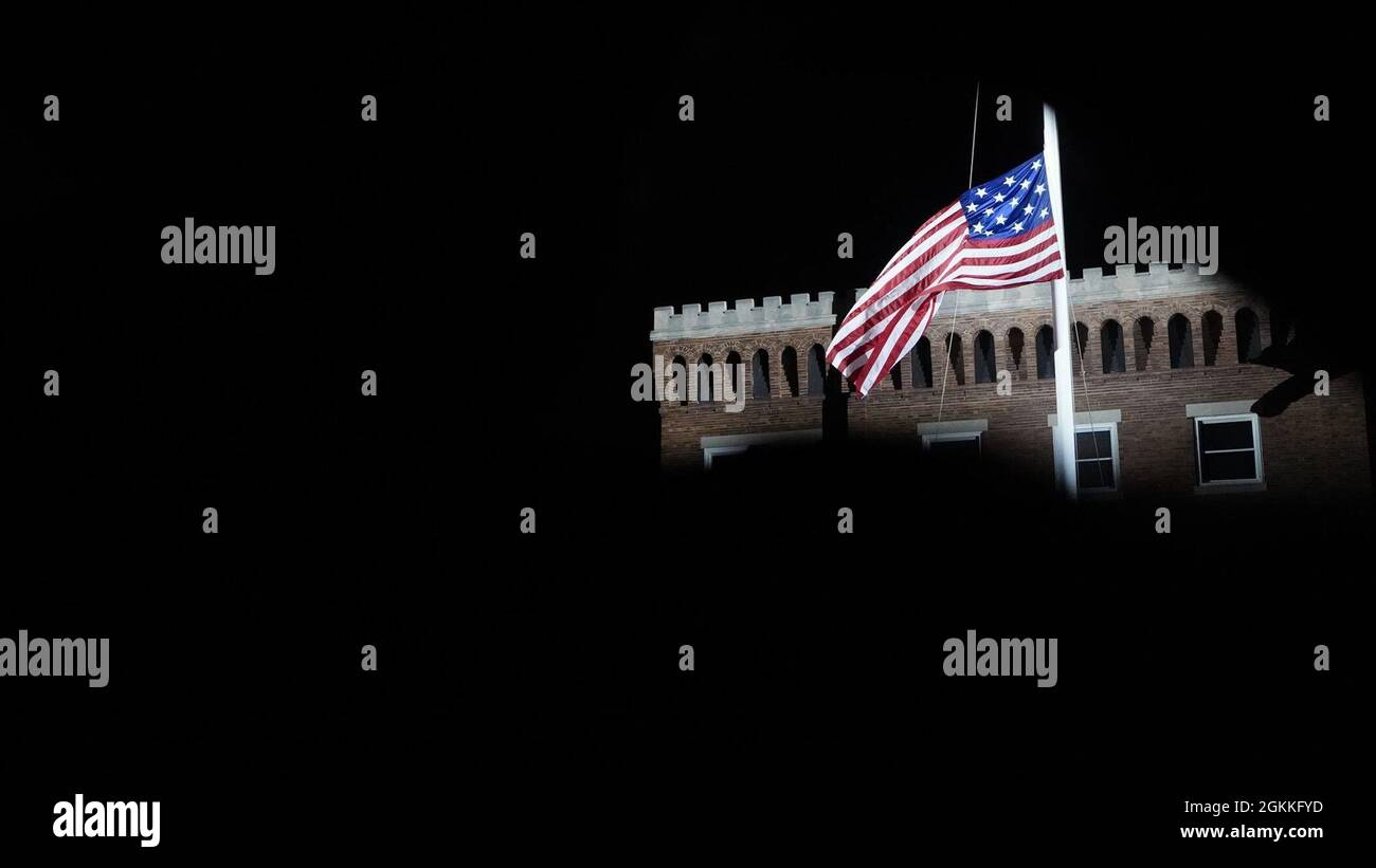 Marines lower a replica of the original flag flown over Marine Barracks ...