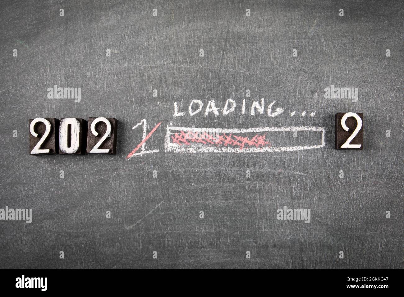 Loading 2022 concept. White wooden figures on a black chalk board Stock ...