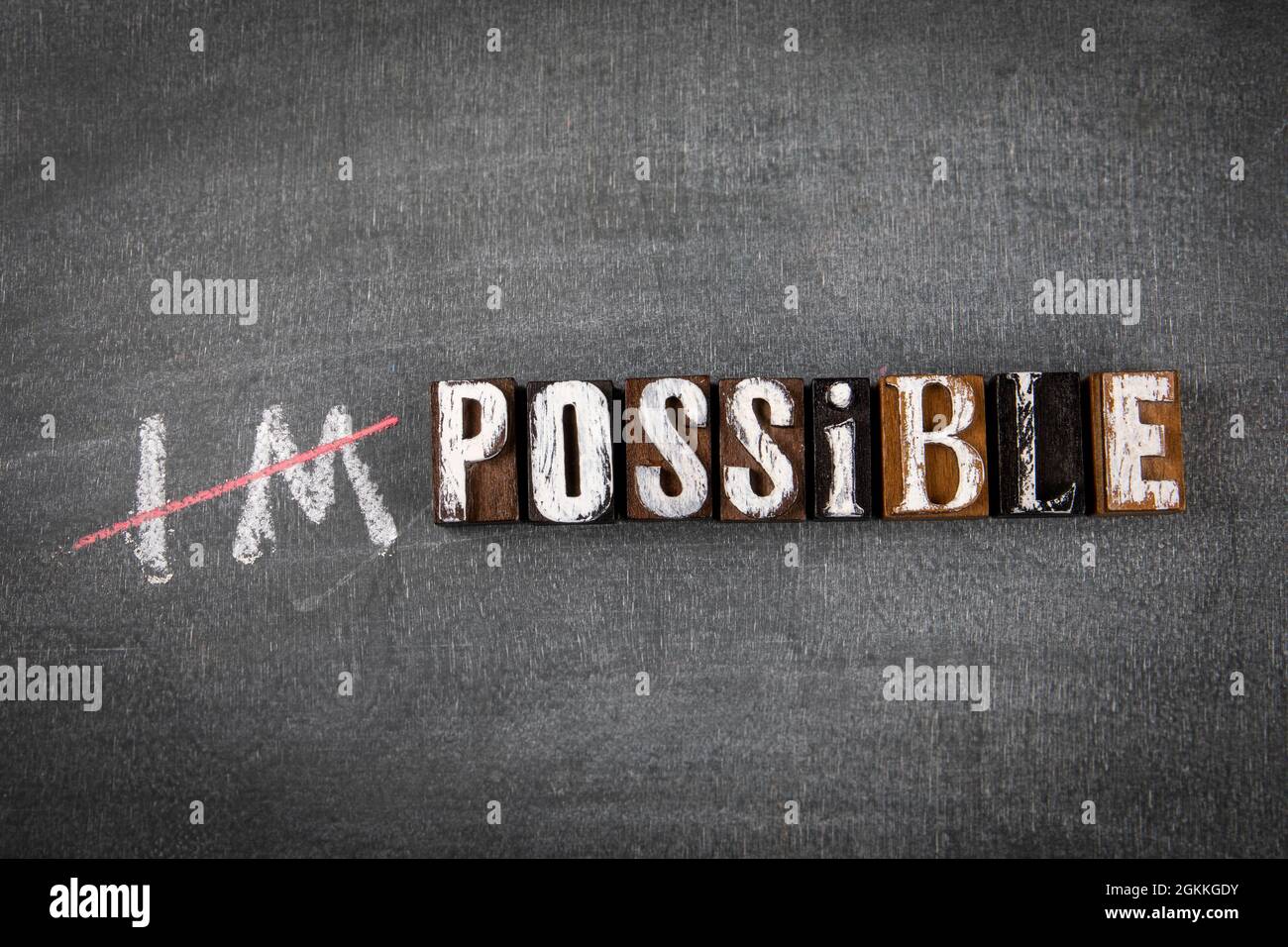 Impossible and Possible Concept. Wooden alphabet letters on a black ...