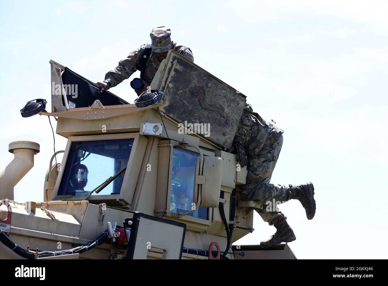 U.S. Army Soldiers climb aboard a grader May 18,2021 as horizontal ...