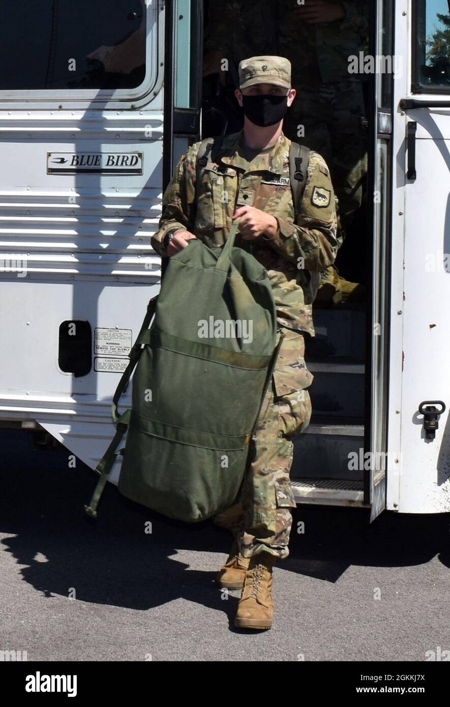 A Specialist from the 1742nd Transportation Company departs the bus ...