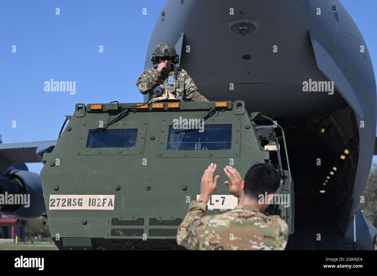 U.S. Army Staff Sgt. Joel Heady, top, a crew chief assigned to Alpha ...