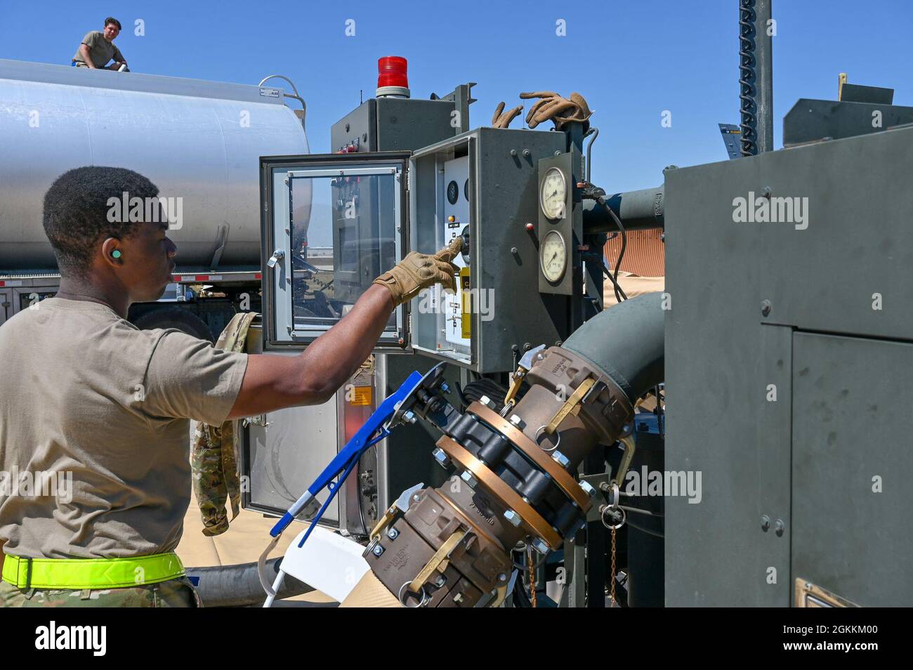 An Air Mobility Command petroleum, oils and lubricants airman pumps ...