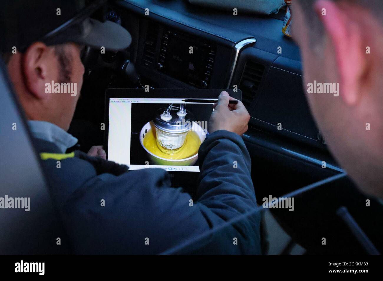 Members of the 10th Civil Support Team's survey team review photos ...