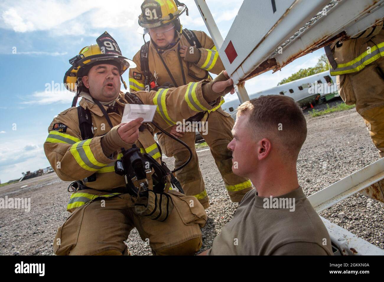 Monclova Township firefighters assess the status of a victim during a ...