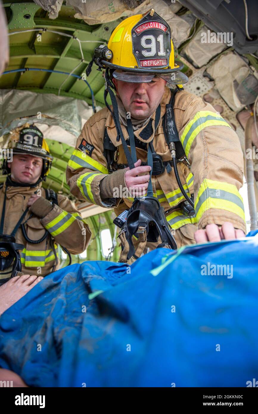 Monclova Township firefighters assess the status of a victim during a ...