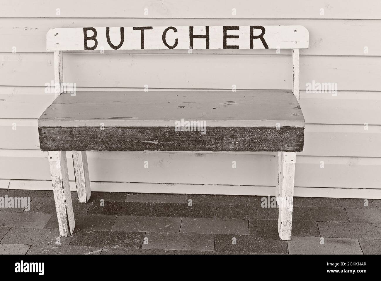 Vintage stool with butcher sign on pavement outside of shop front ...