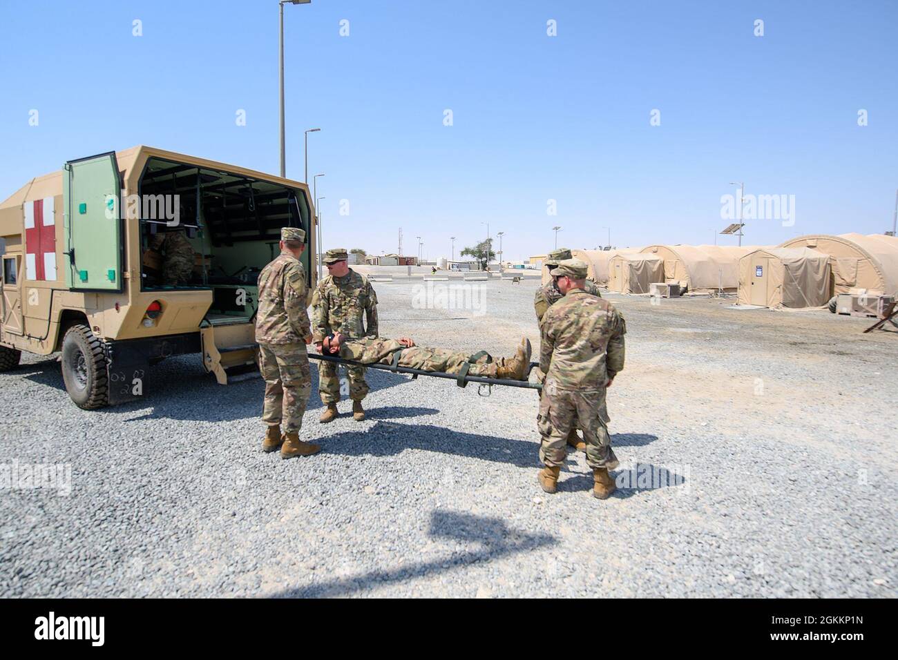 U.S. Air Force and Army medics perform a four-man litter carry as part ...