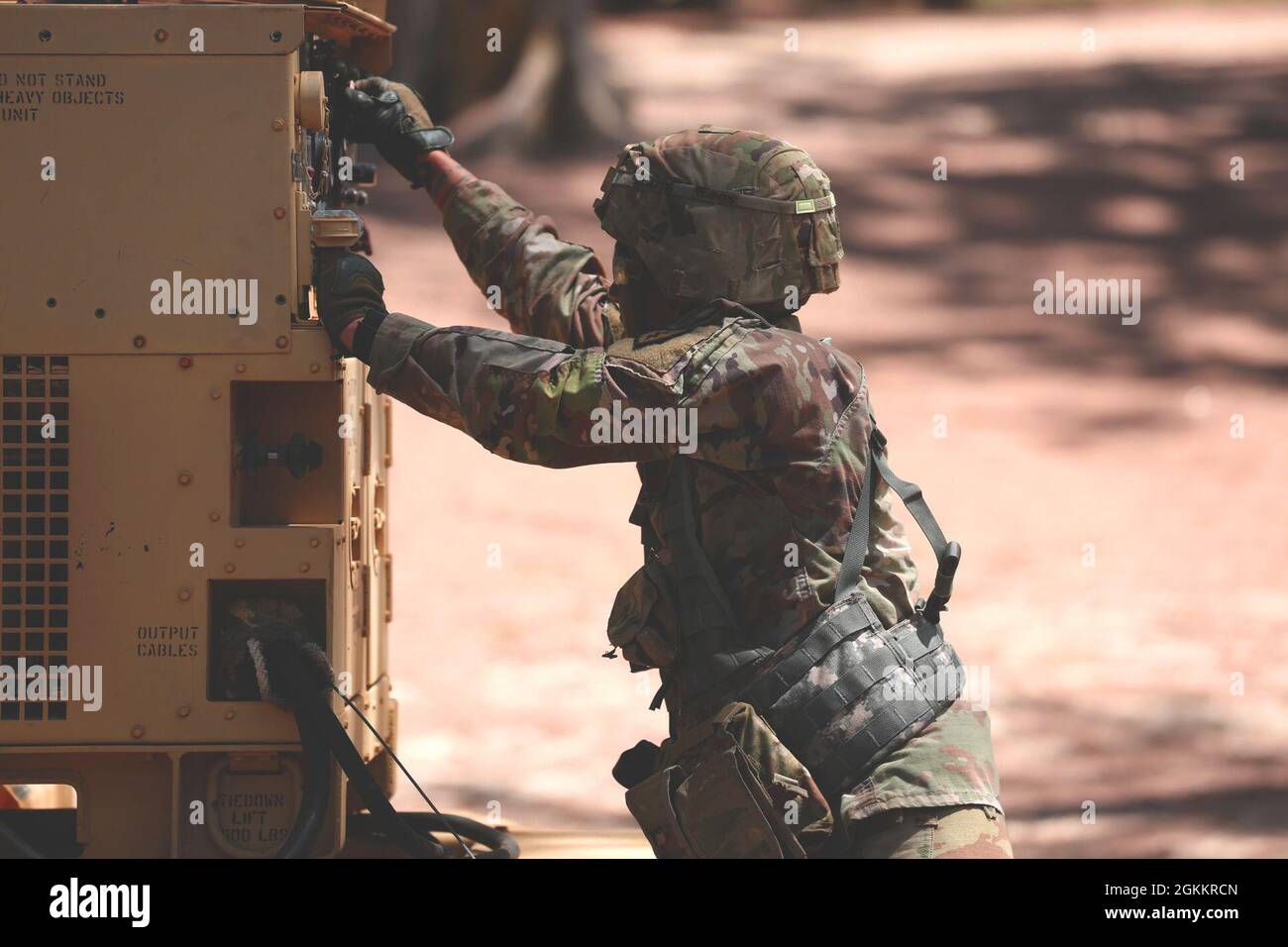 A soldier starts up a generator during the Signal Digital Gunnery Table ...