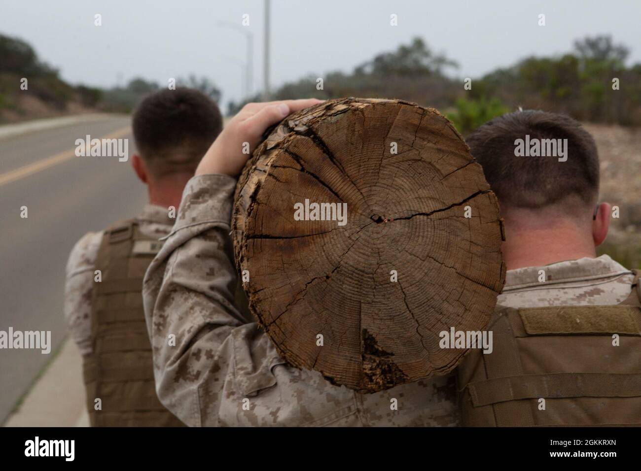 U.S. Marines with Marine Corps Air Station Miramar carry a log during a ...