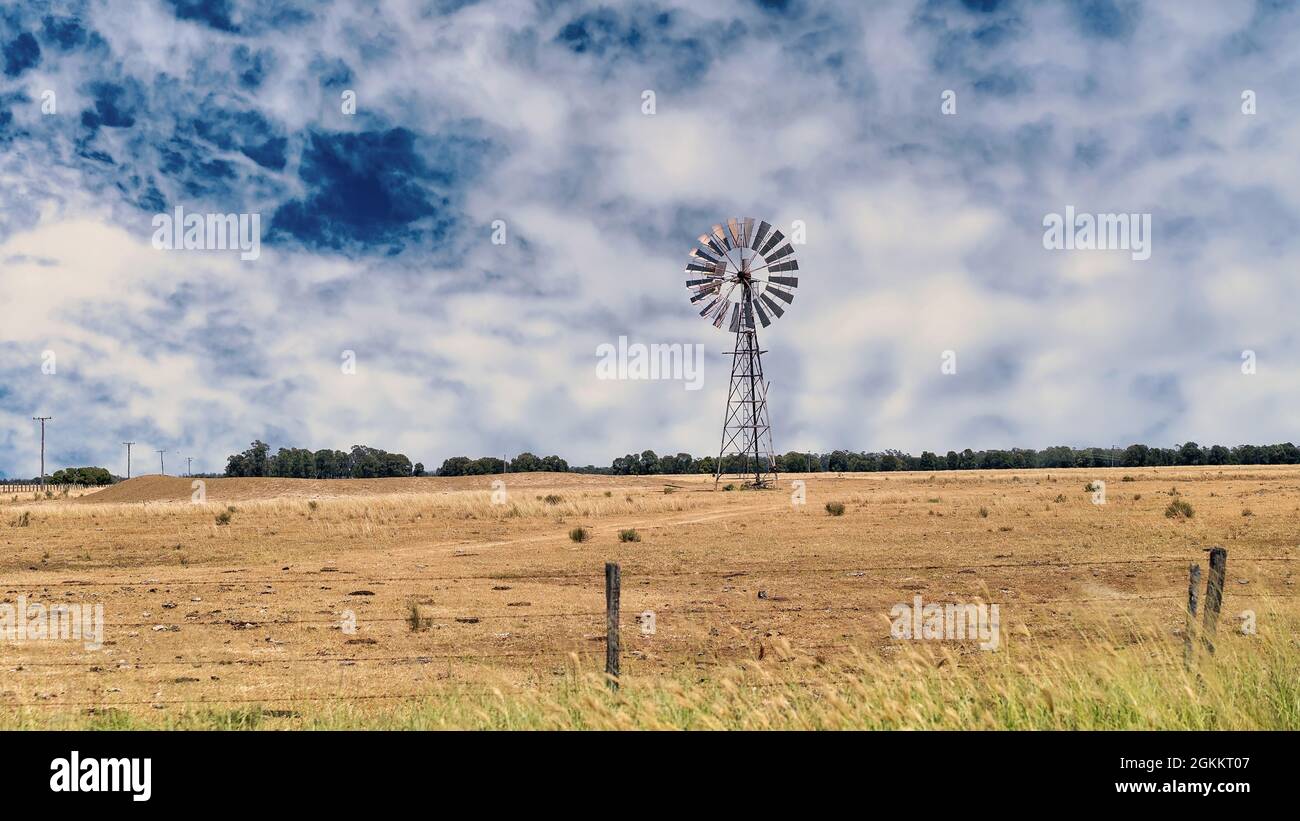 A windmill standing in a paddock of vast open space in Australian ...