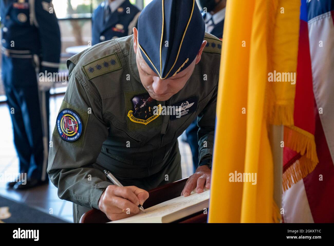 Colombian Air Force Commander, Gen. Ramses Rueda, signs a guest book in ...