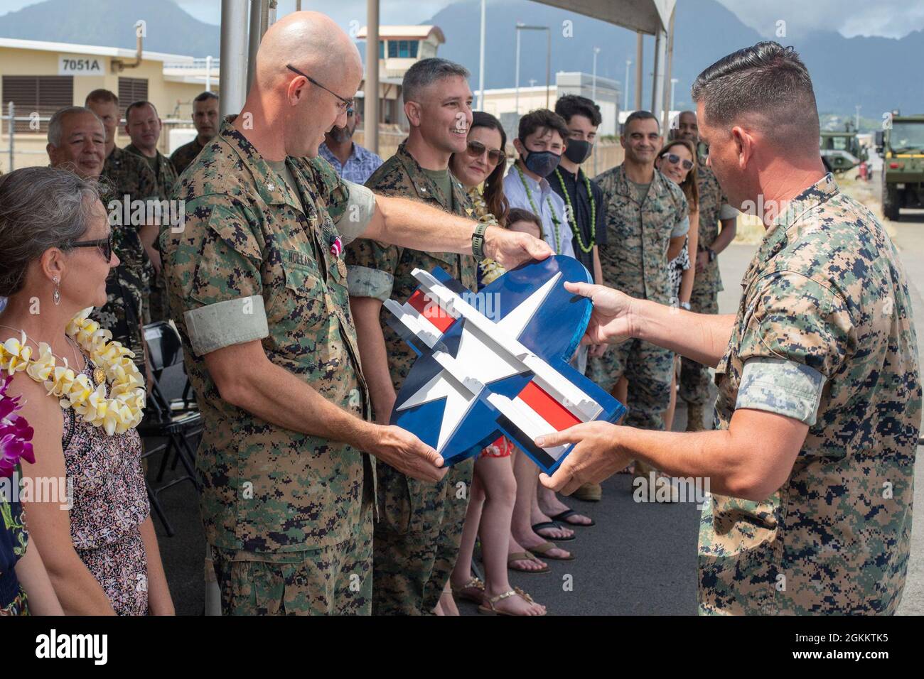 U.S. Marine Corps Lt. Col. Tyler Holland receives a gift from his ...