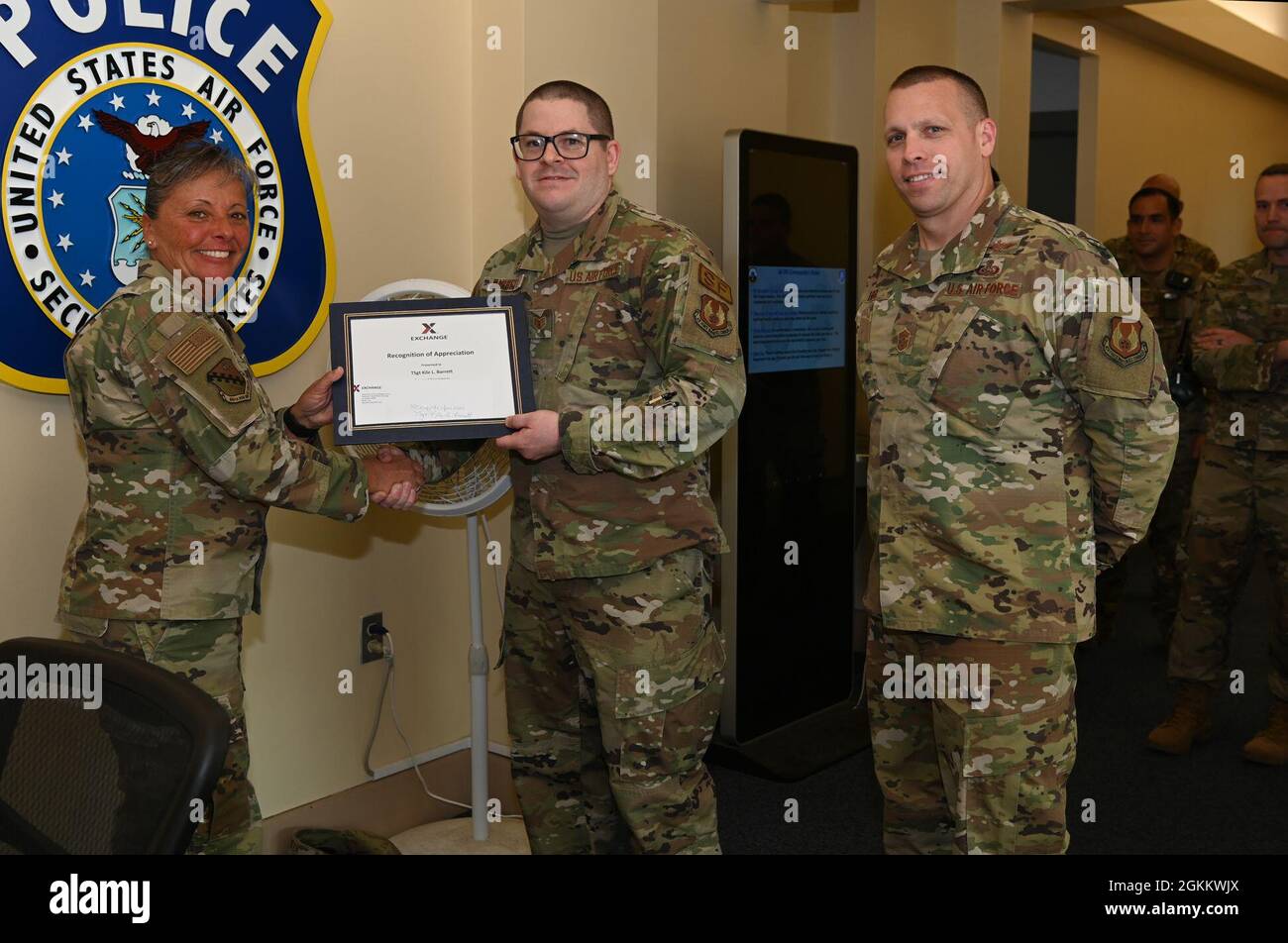 Col. Katrina Stephens, left, installation commander, presents a ...