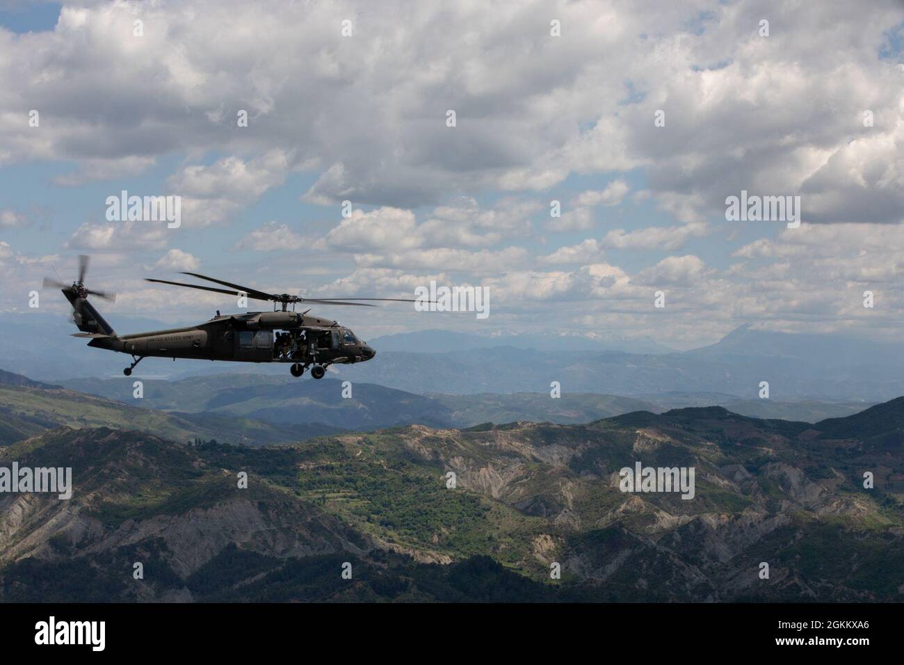 (FARKE AIRFIELD, Albania) --- A UH-60 Blackhawk flies over the Kodra e ...
