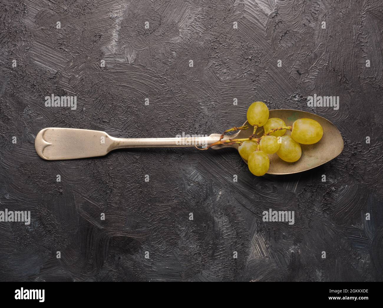 Fresh organic grapes on a rustic spoon on a dark background, super food ...