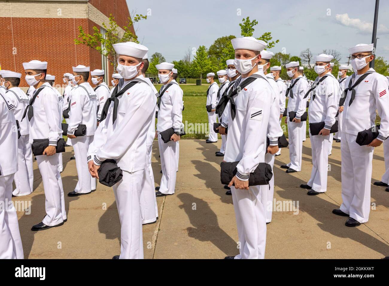 Graduating Sailors stand in formation before their pass-in-review ...