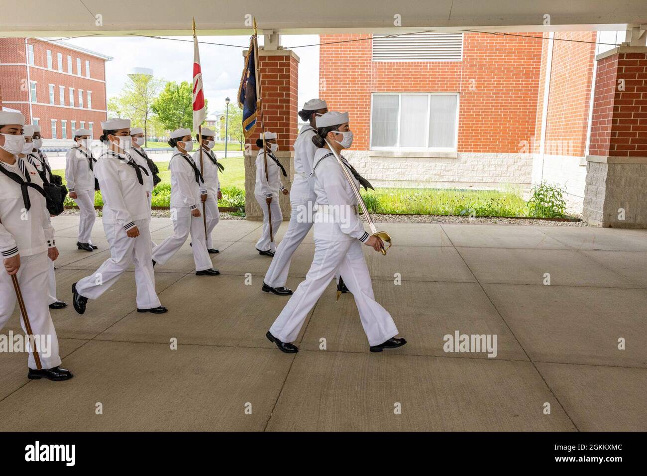 Graduating Sailors march in formation during their pass-in-review ...