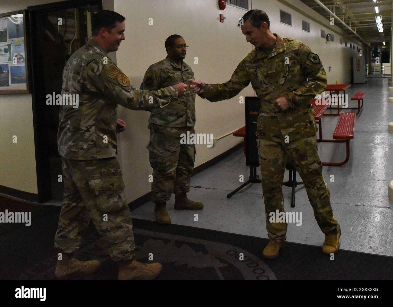 U.S. Air Force Lt. Gen. Kevin Schneider, 5th Air Force commander, hands ...