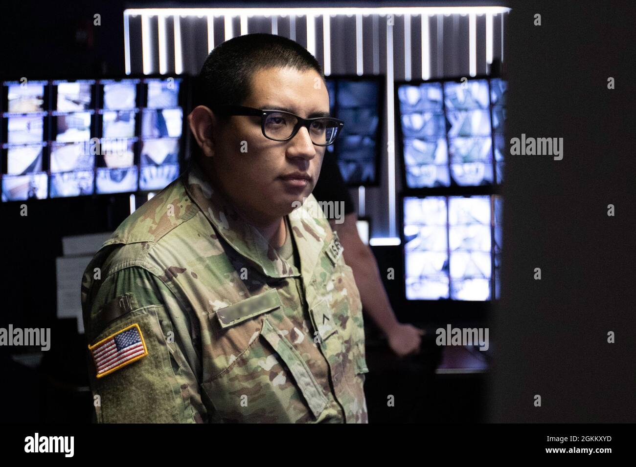 An Arizona Guardsmen observes security monitors at the Pinal County ...