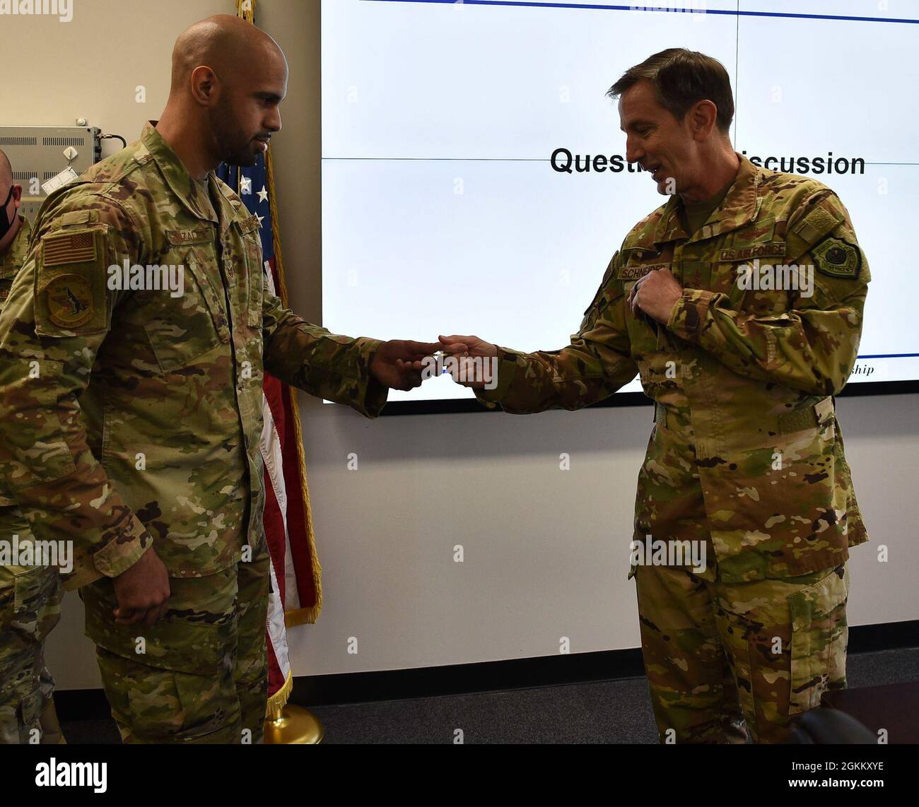 U.S. Air Force Lt. Gen. Kevin Schneider, 5th Air Force commander, coins ...