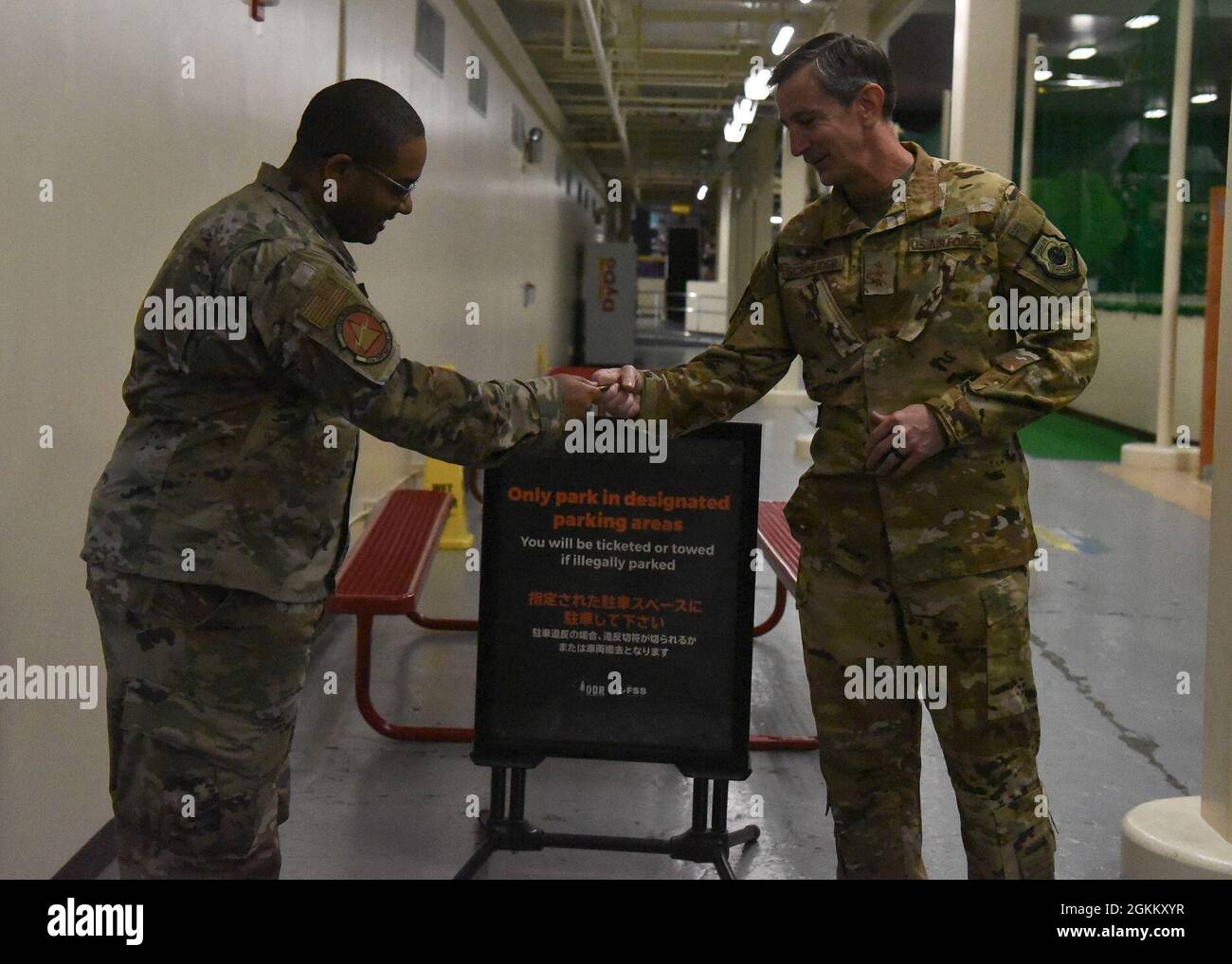 U.S. Air Force Lt. Gen. Kevin Schneider, 5th Air Force commander, coins ...