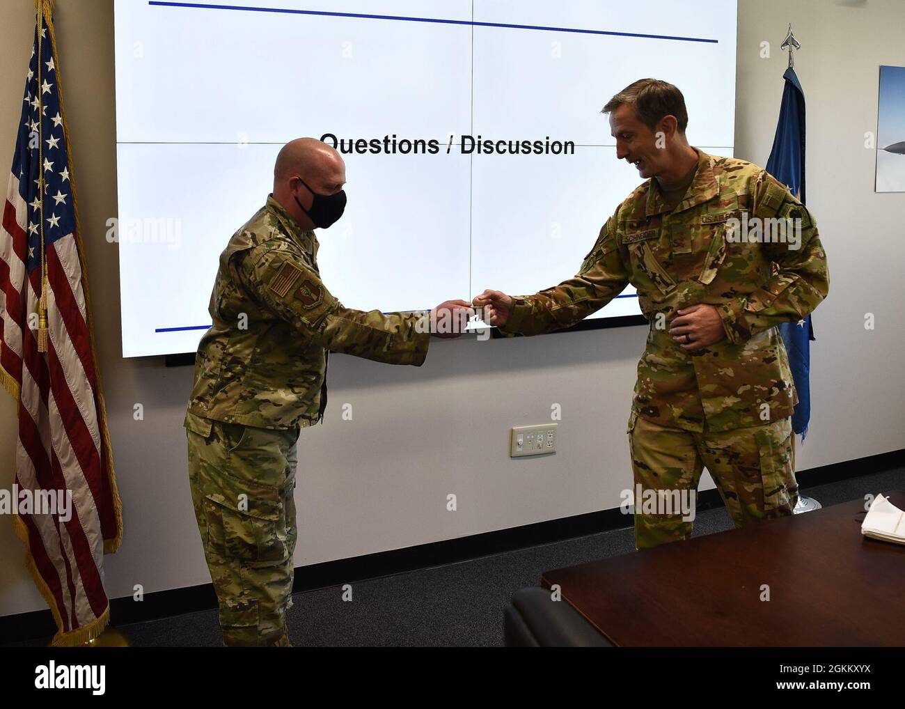 U.S. Air Force Lt. Gen. Kevin Schneider, 5th Air Force commander, coins ...