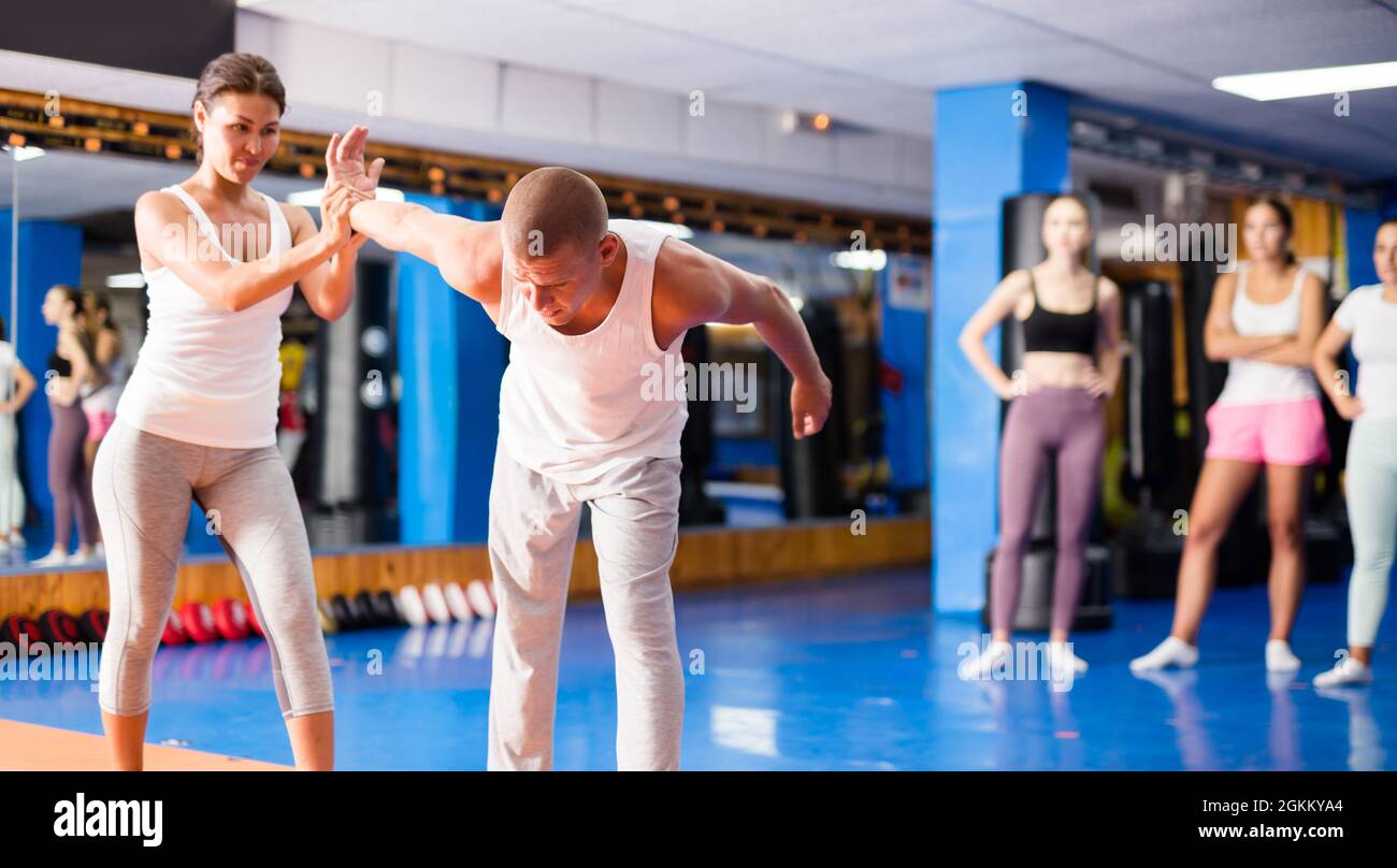 Asian woman practicing self-defence moves with her trainer Stock Photo ...