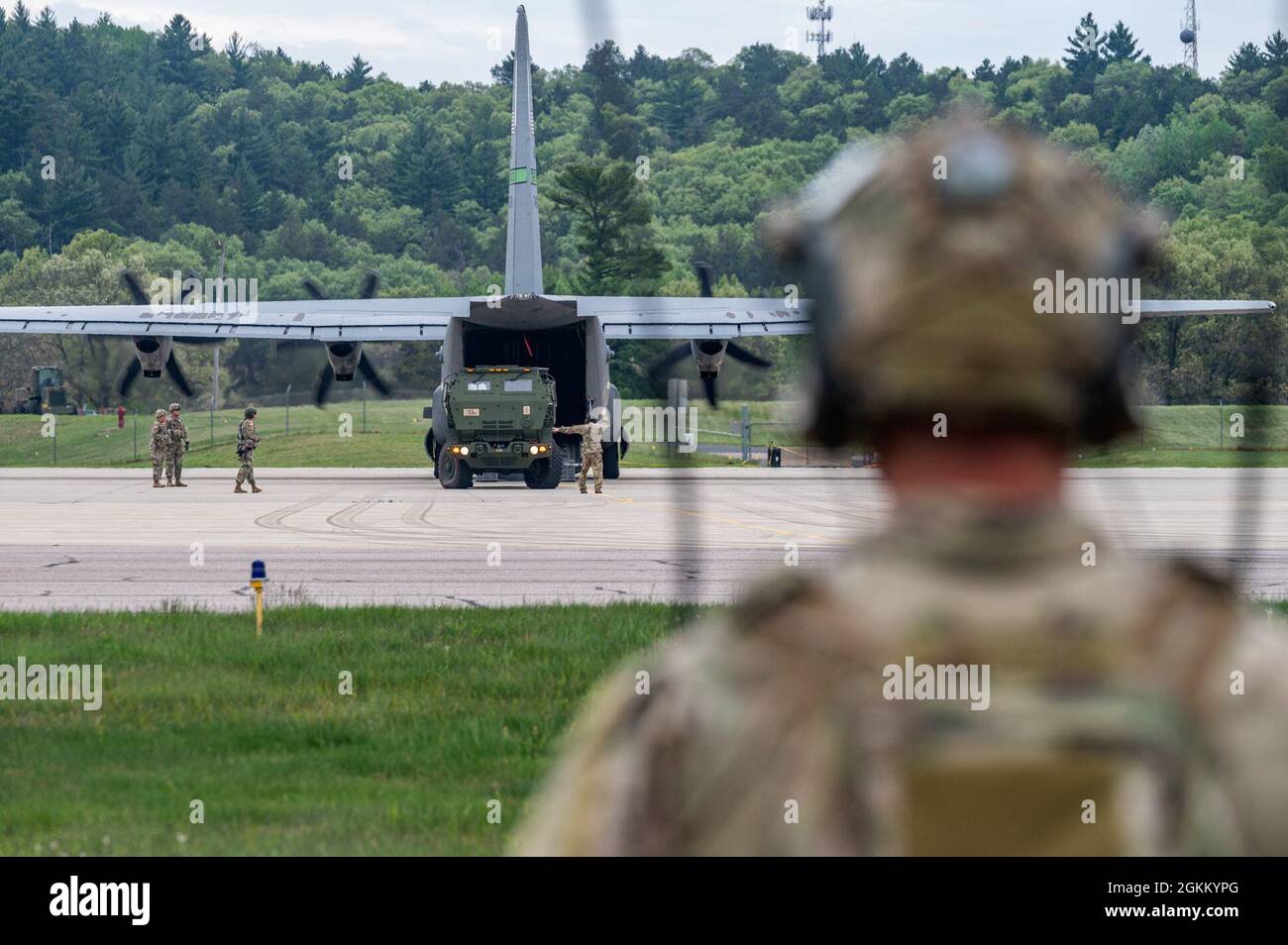 A U.S. Air Force Special Tactics operator watches as C-130 Hercules ...
