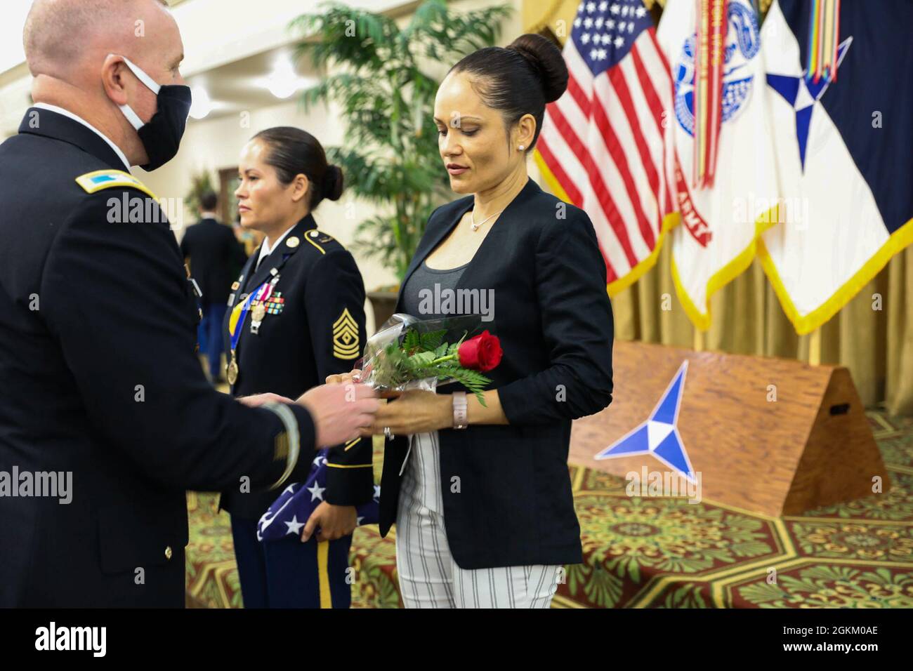 Donna Alston receives a red rose during her sisters retirement ceremony ...