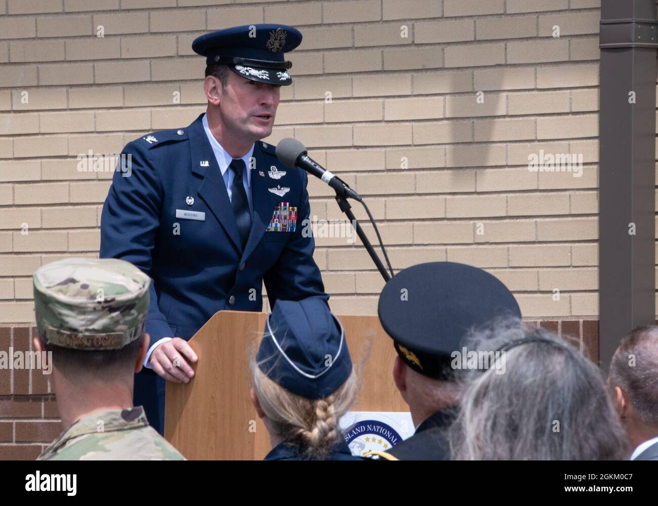 The 143d Airlift Wing commander, Col. Adam G. Wiggins, speaks during a ...