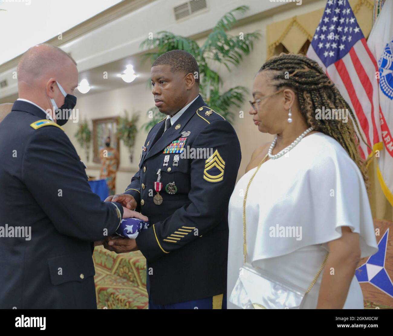 Sgt. 1st Class Antonio Holliday, 1st Cavalry Division, receives a flag ...