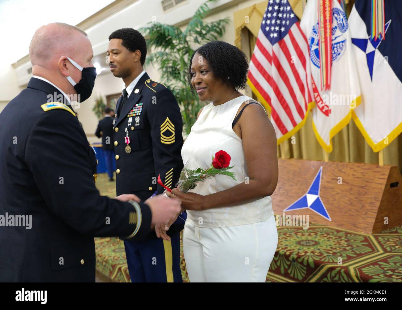 Mrs. Sonya Anthony receives a red rose during her husbands retirement ...