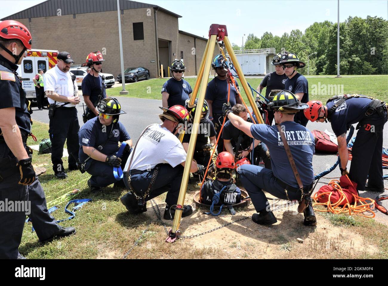 Two Fort Knox firefighters work together within an open manhole to ...