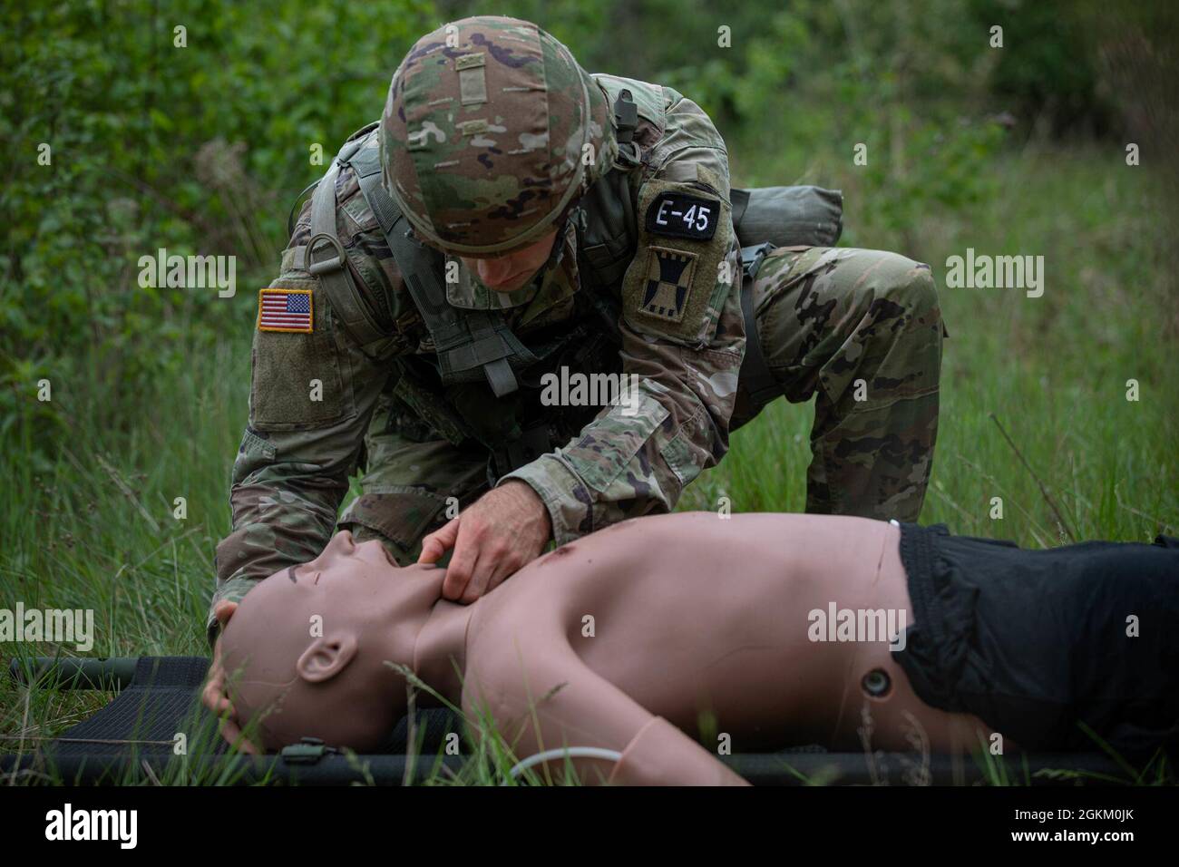 A U.S Army Reserve Soldier performs the head, tilt, chin lift maneuver ...