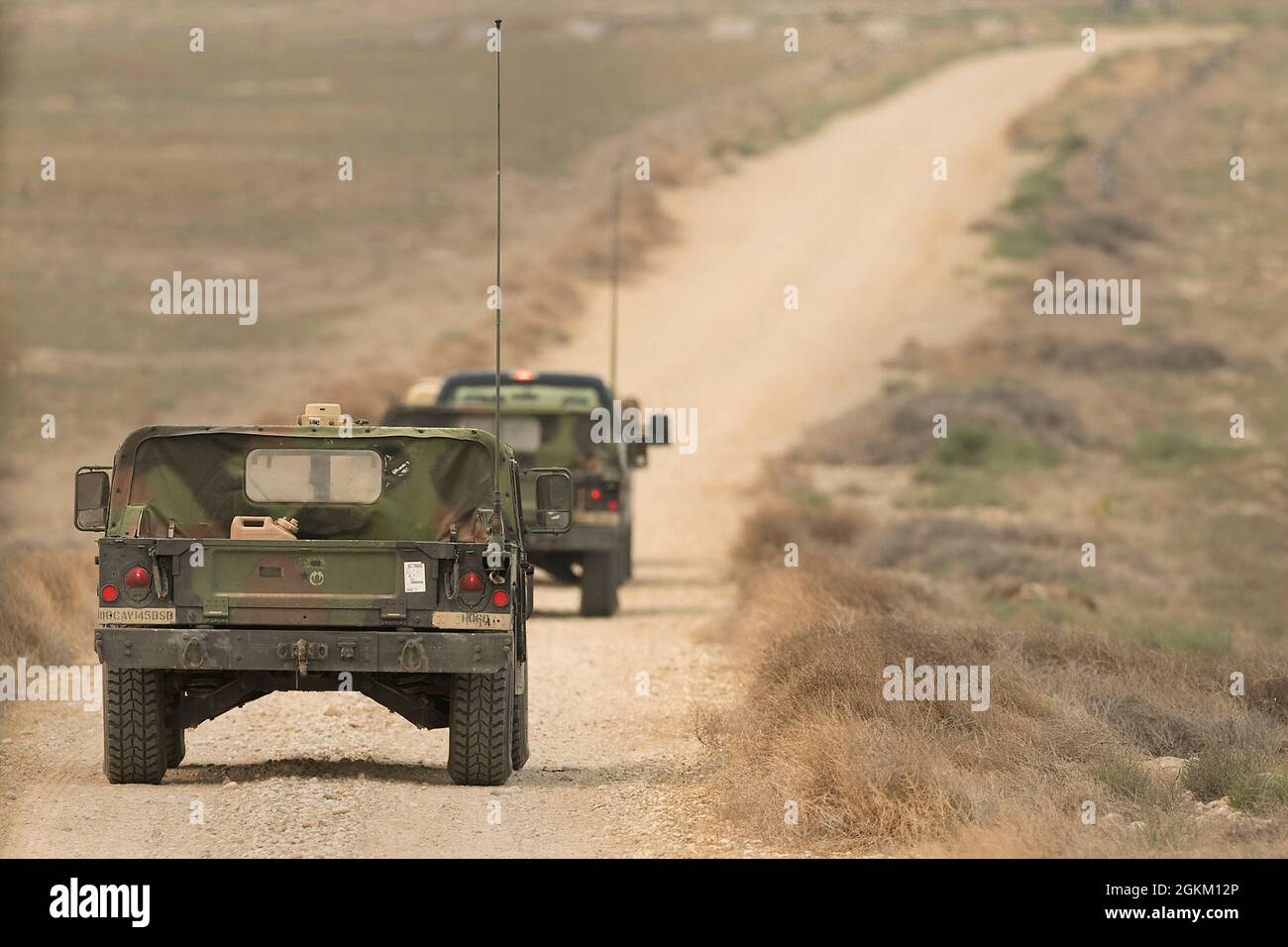 The lead vehicles of C Company begin their way down the road. One of ...