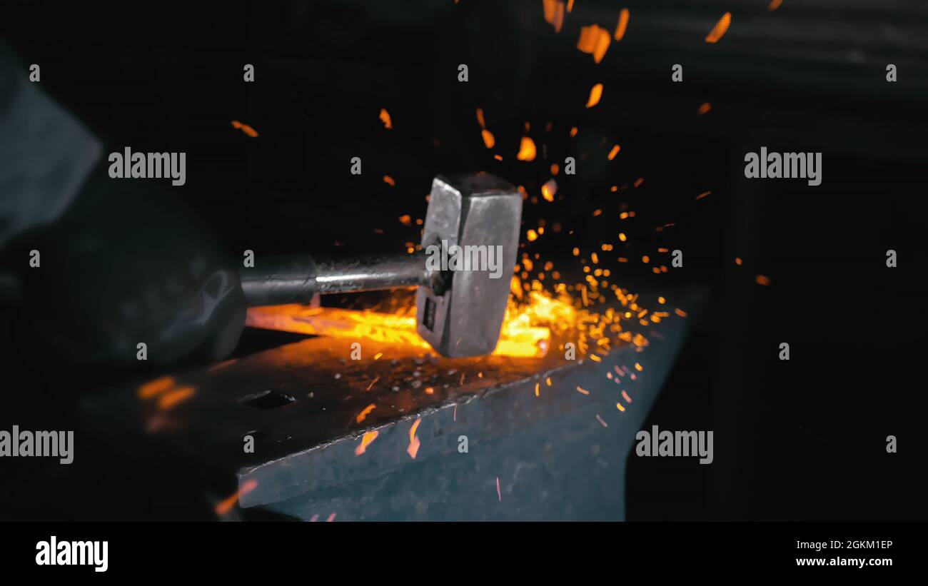 Forge workshop. Smithy manual production. Hands of smith with hammer ...