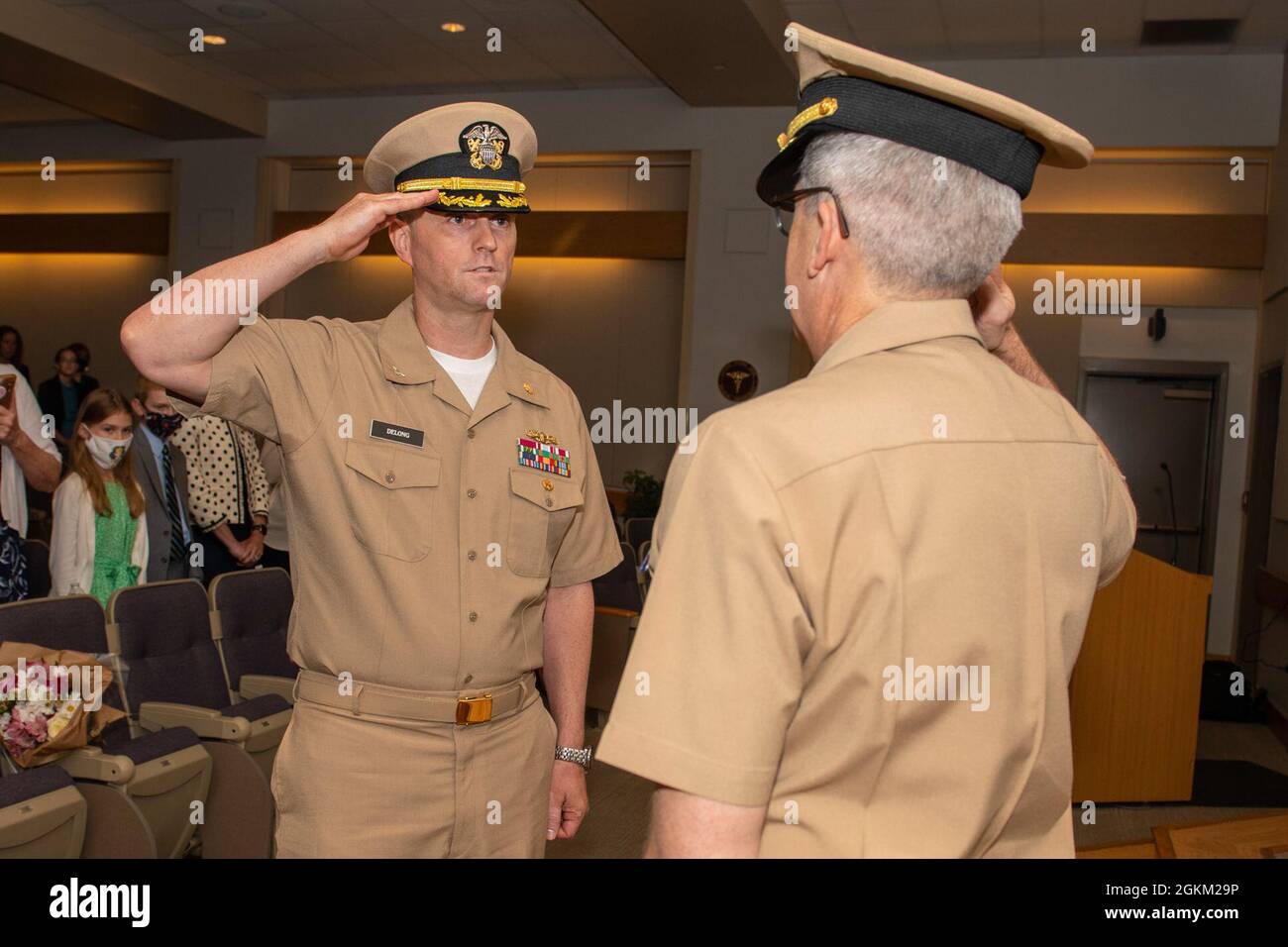 U.S. Navy Capt. Gerald DeLong salutes U.S Navy Capt. Adam Armstrong ...