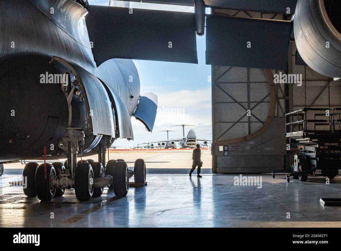 A C-5M Super Galaxy is parked in a hangar for inspection and service ...