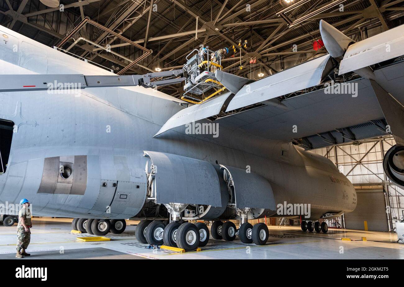 Senior Airman Tyler Bryce, left, spots Staff Sgt. Brandin Josey, center ...