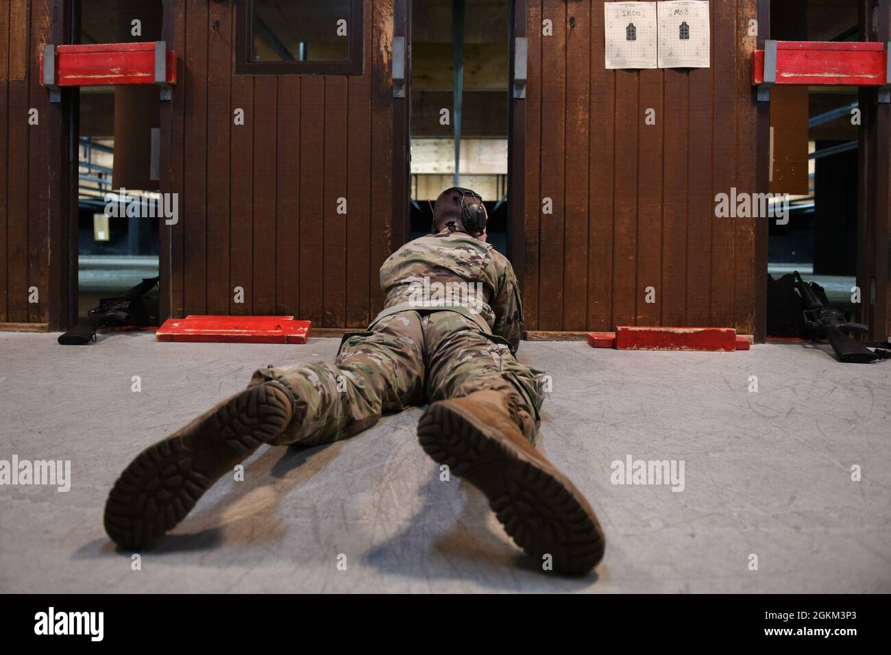 An Airmen lays in the prone position waiting to fire his rifle at the ...