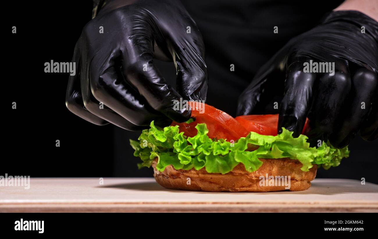 Craft burger is cooking. Consist: red sauce salsa, lettuce, red Stock ...
