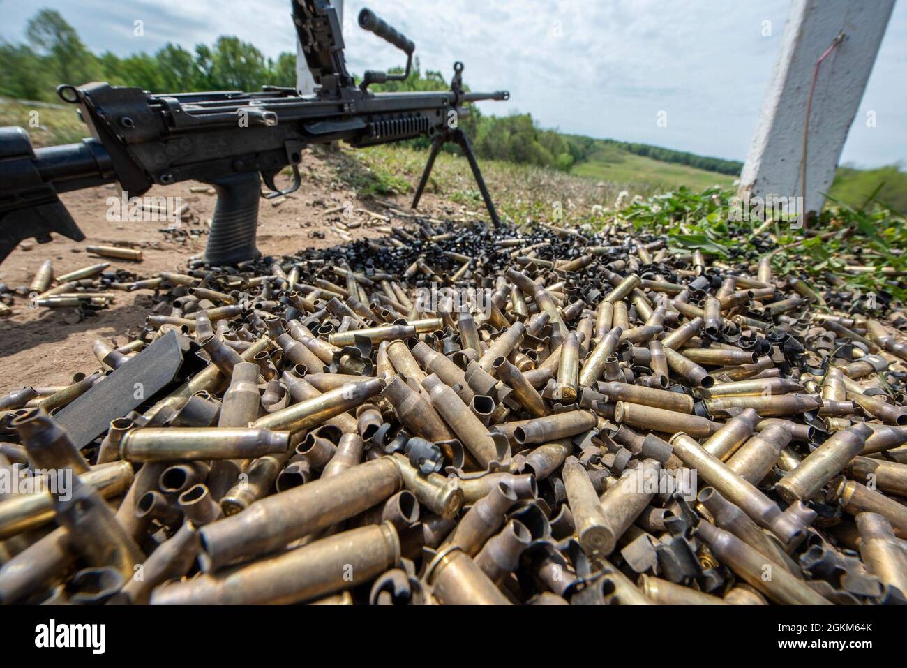 A pile of empty bullet casings lay on the ground after being fired from ...
