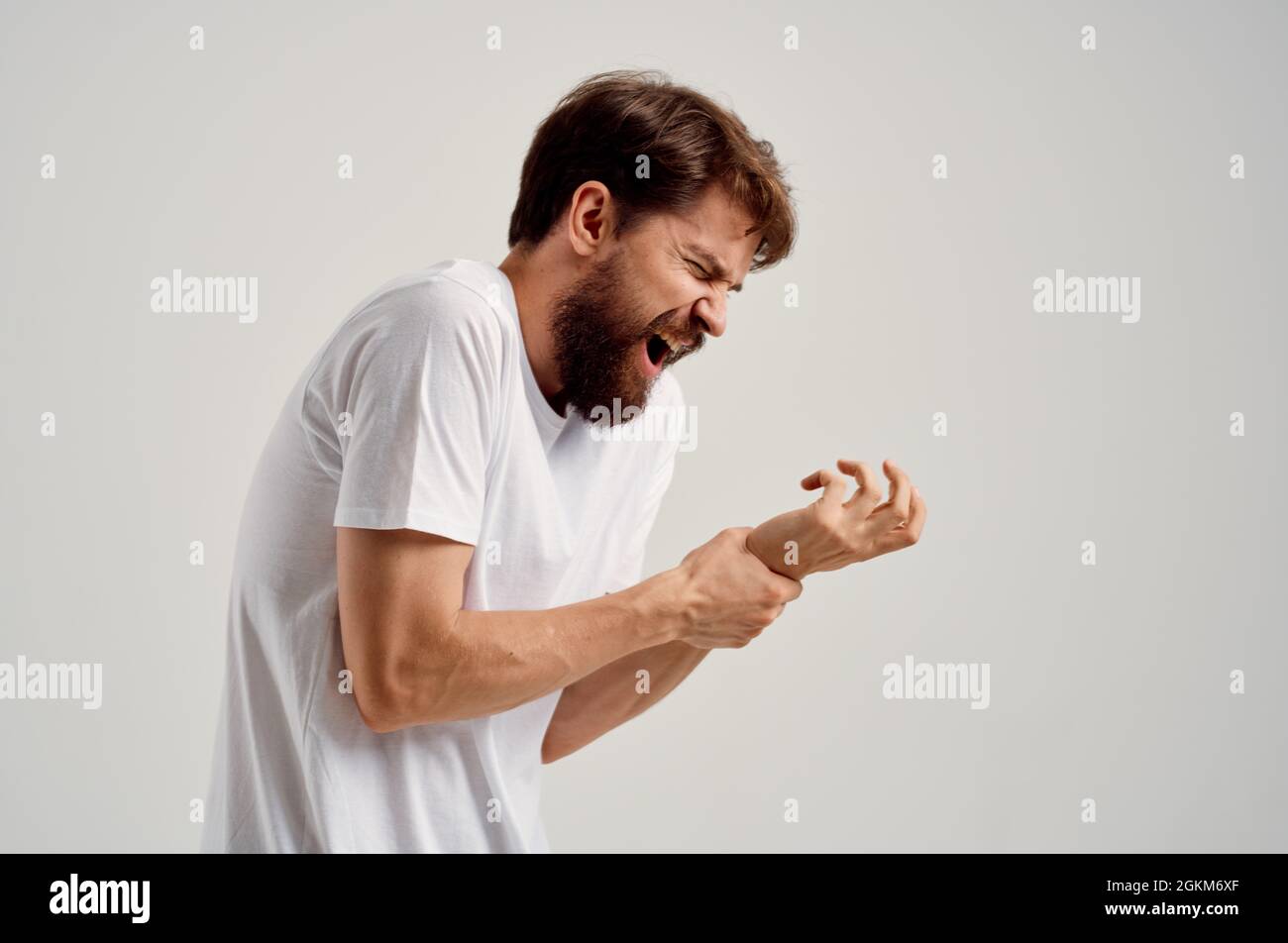 man holding hand injury health problem Stock Photo - Alamy