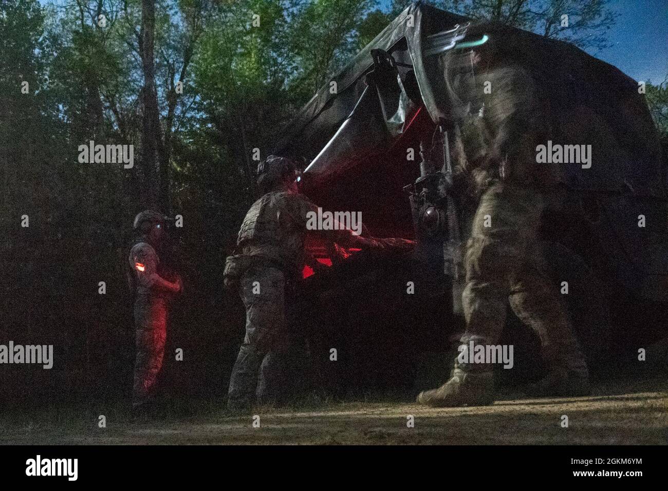 U.S. Air Force Special Tactics operators load an injured simulated ...