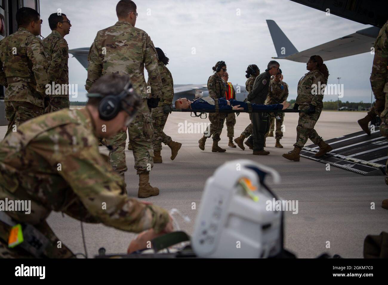 U.S. Air Force aeromedical evacuation team members unload simulated ...