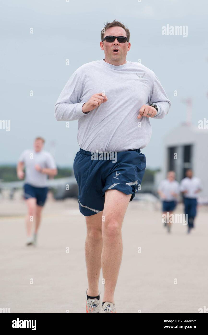 A U.S. Air Force Airman crosses the finish line at the 5K Runway Series ...