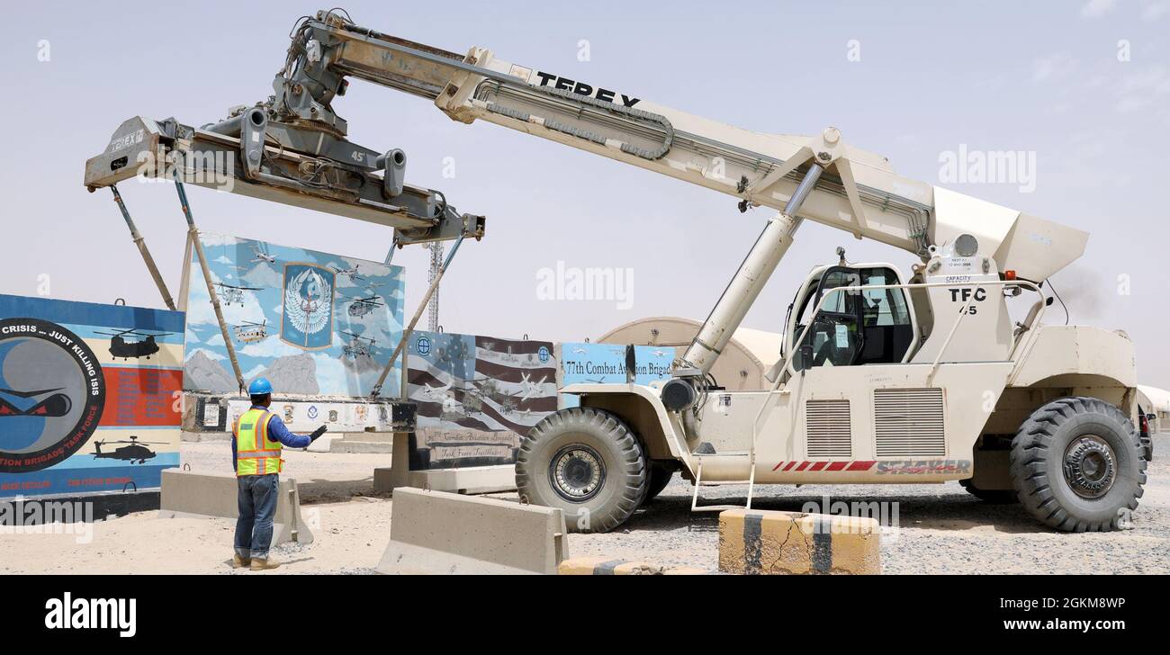 Contractors place a T-wall in front of the Tactical Operations Center ...