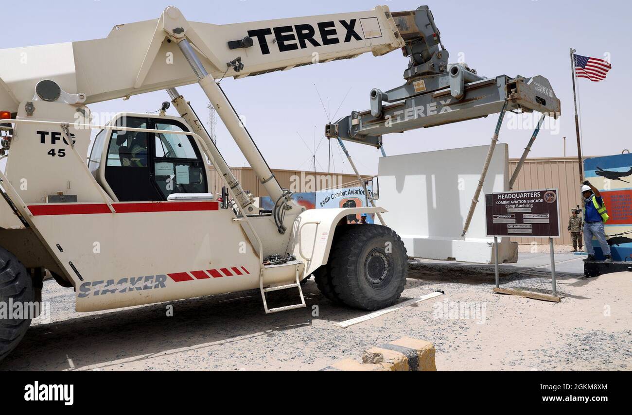 Contractors place a T-wall in front of the Tactical Operations Center ...